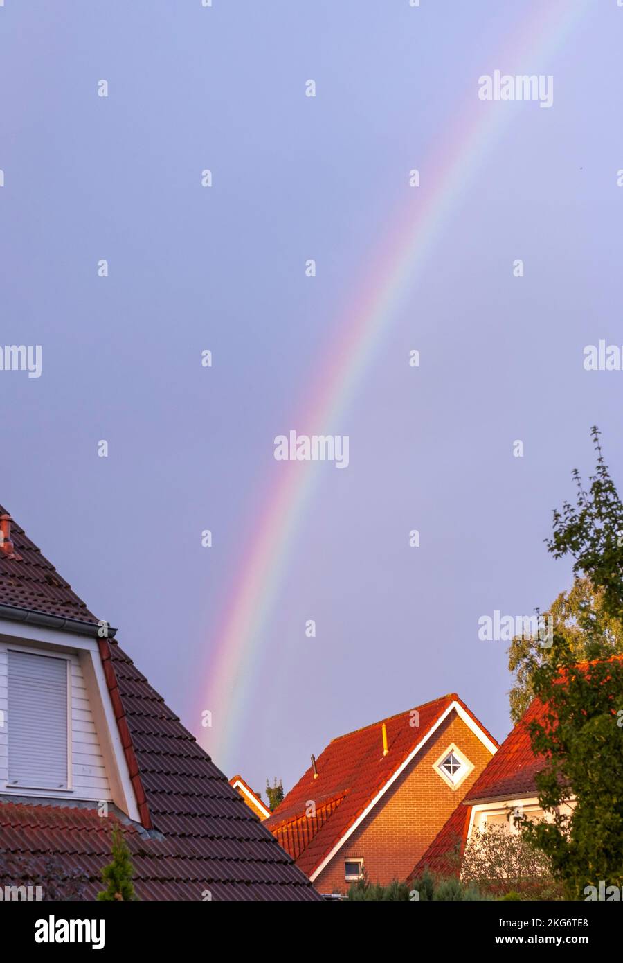 rainbow rising through the roofs, weather events and rainbow Stock ...