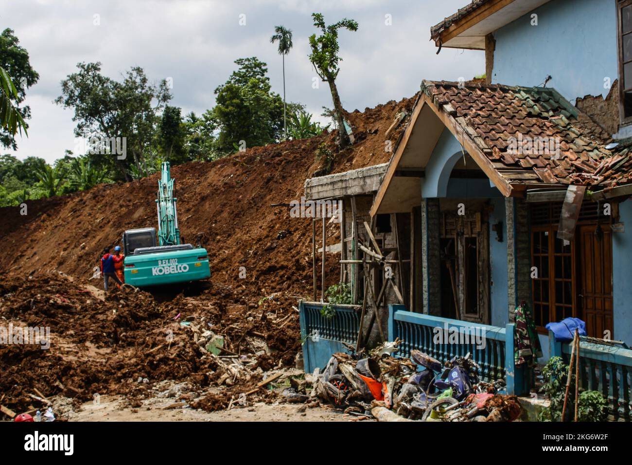 Cianjur, West Java, Indonesia. 22nd Nov, 2022. Workers use heavy equipments to remove soils ...