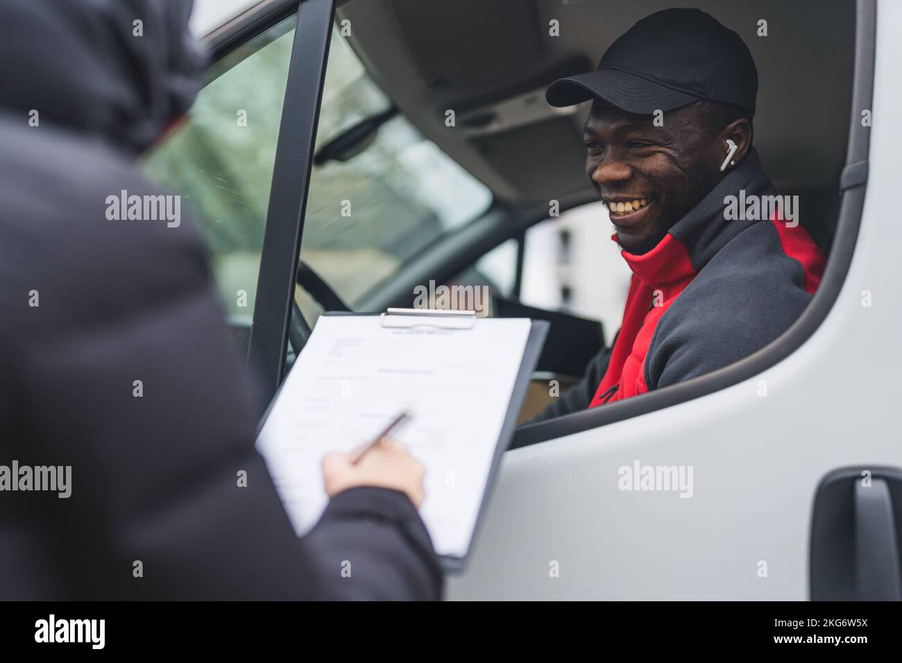 Mail and post packages concept. Unrecognizable person in black jacket ...