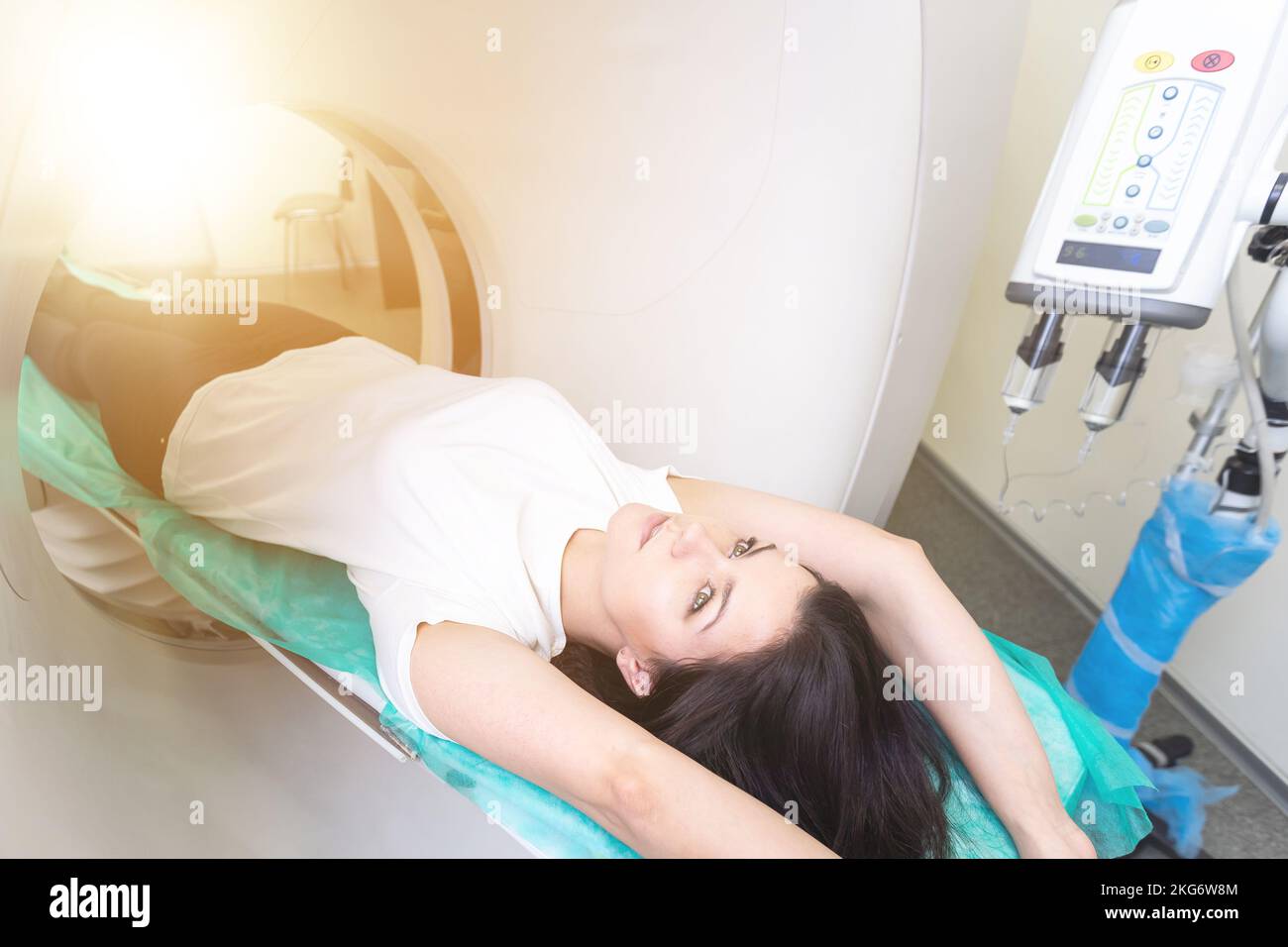 Radiologist with a female patient in the room of computed tomography ...