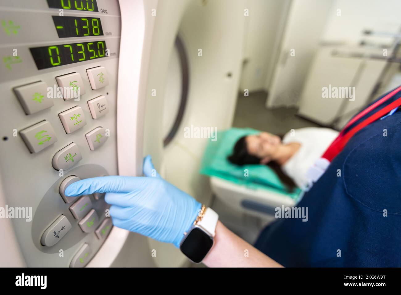 Radiologist with a female patient in the room of computed tomography ...