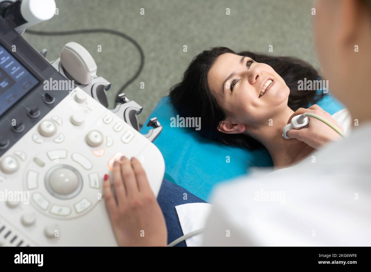 Ultrasound scanning diagnostic of woman thyroid gland in clinic, doctor ...