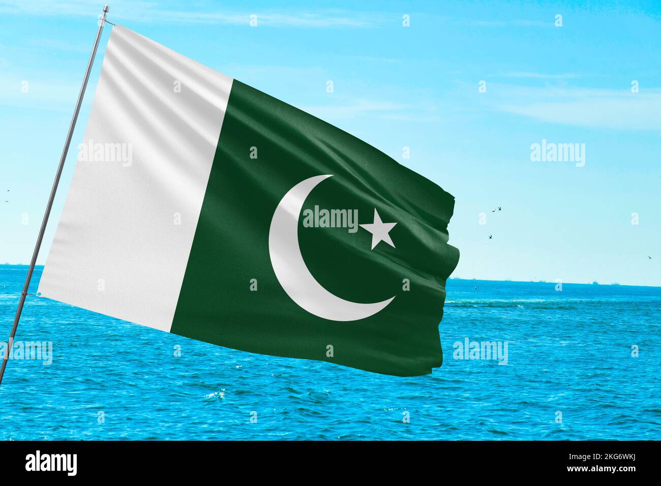 Pakistan National Flag waving on high seas with blue sea and sky in ...