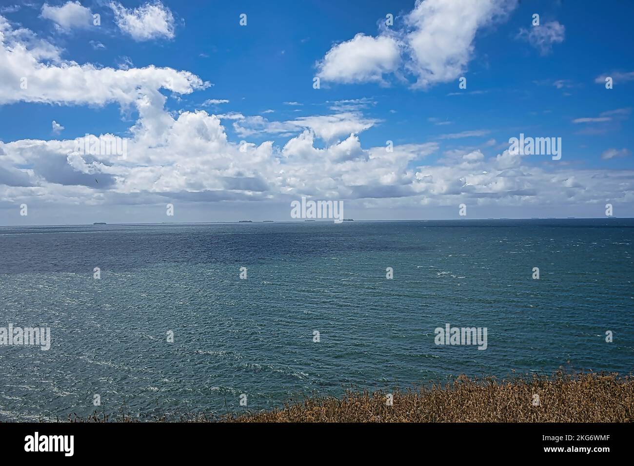 A scenic view of the calm sea under the cloudy sky Stock Photo - Alamy