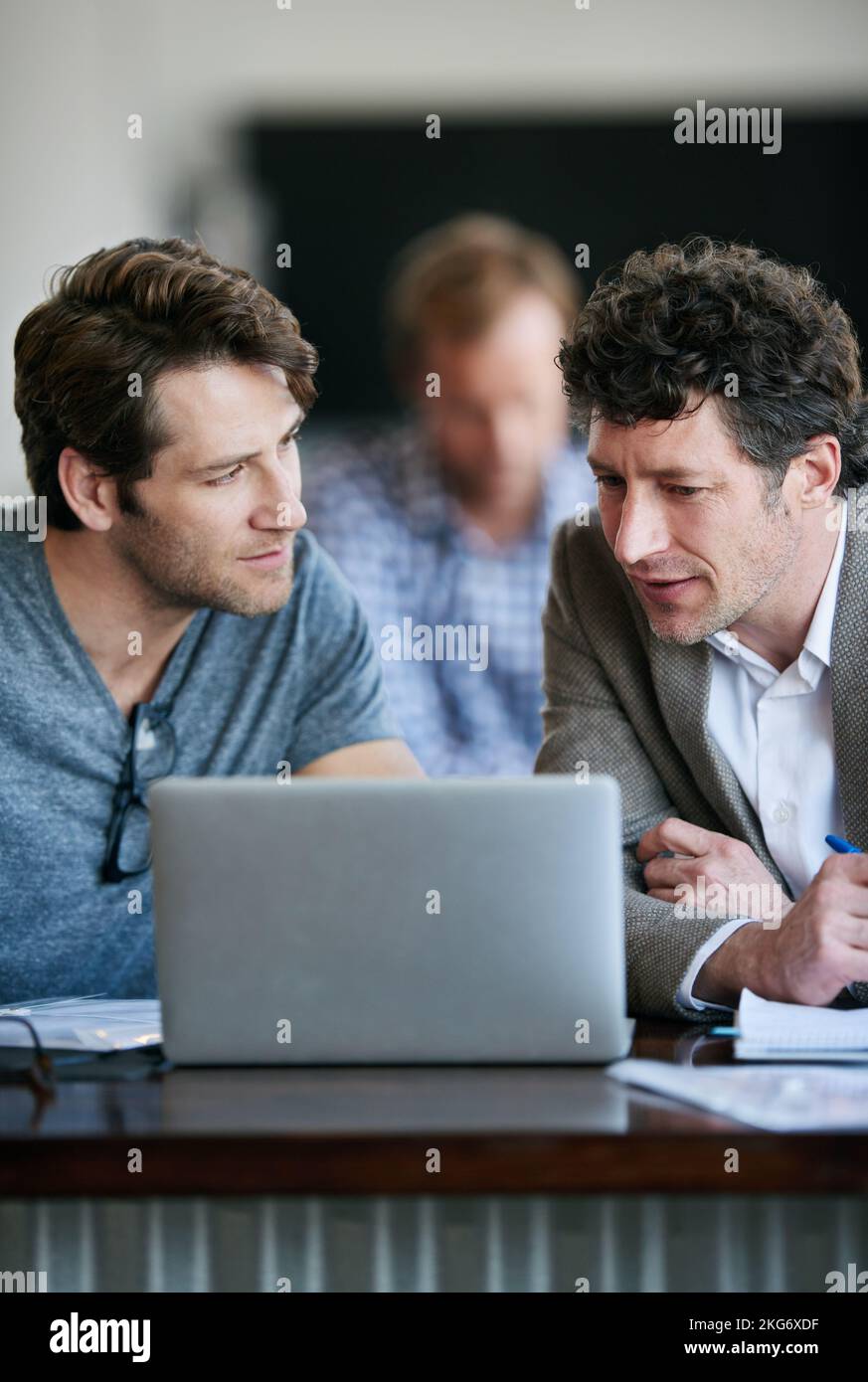 Are these figures correct. two businessmen looking over some work with ...