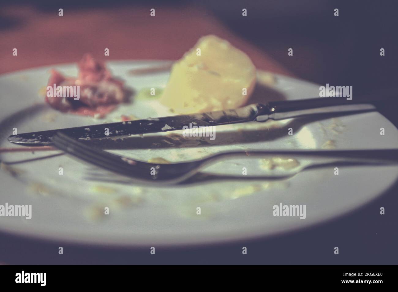 An empty plate after dinner with just a potatoe as leftover Stock Photo ...
