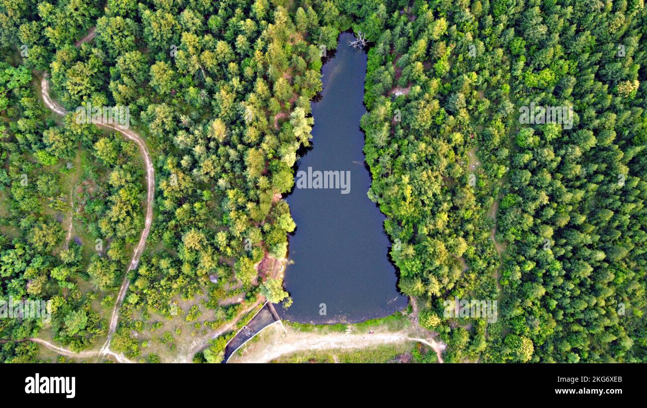 An aerial of a triangular-shaped lake in the middle of the woods Stock ...