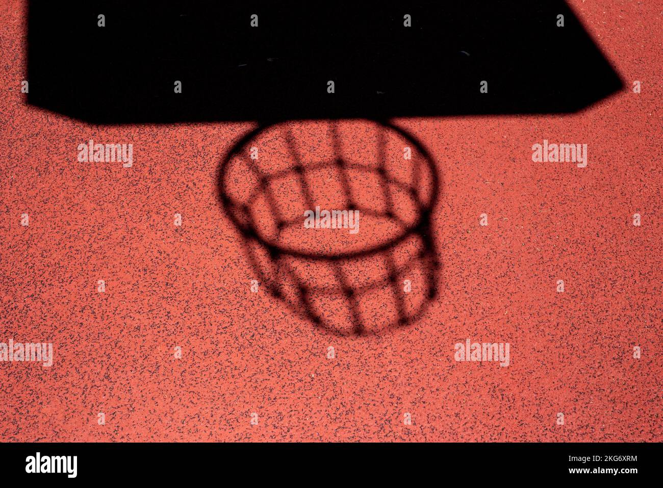 A shadow of a basketball hoop on a red ground Stock Photo - Alamy