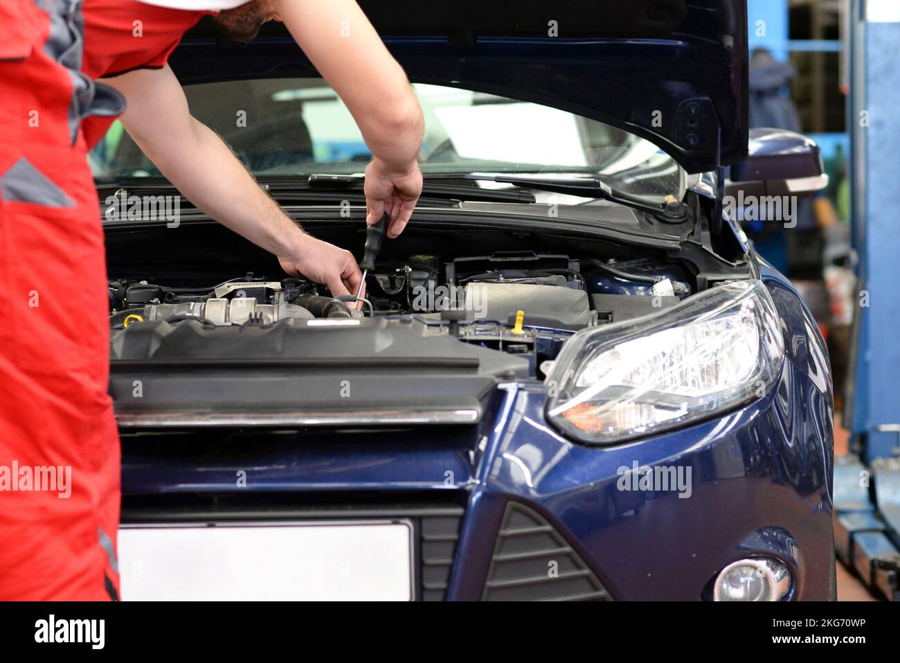mechanic in a workshop checks and inspects a vehicle for defects Stock ...