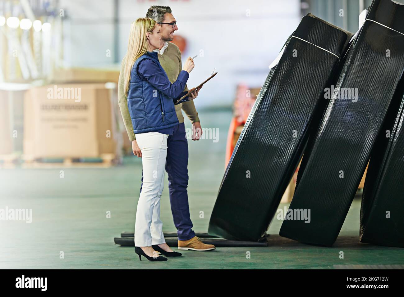 Theyre hands on factory managers. a two managers examining product ...