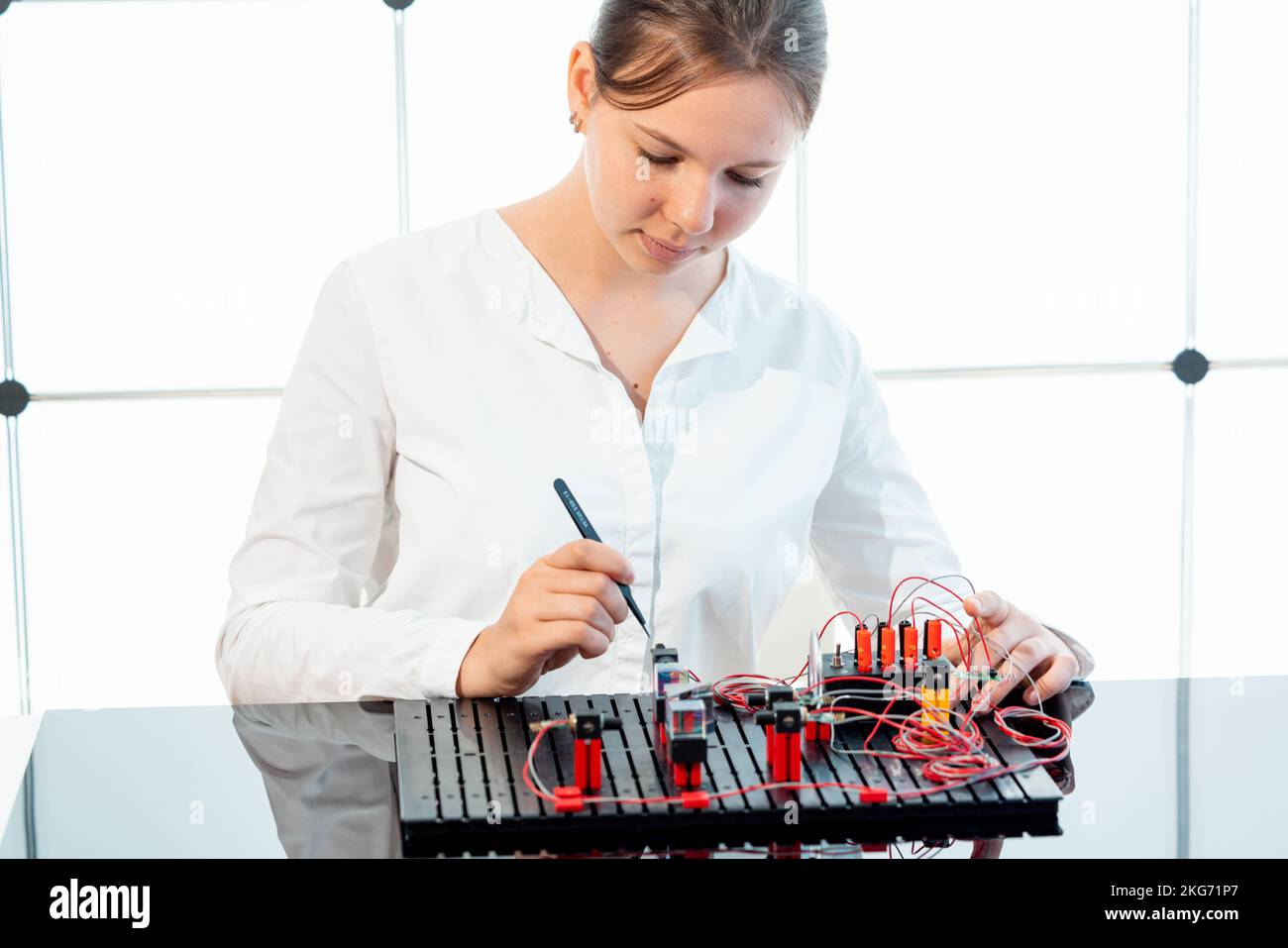 schoolgirl student studying electrical circuits at a physics lesson ... schoolgirl student studying electrical circuits at a physics lesson ...