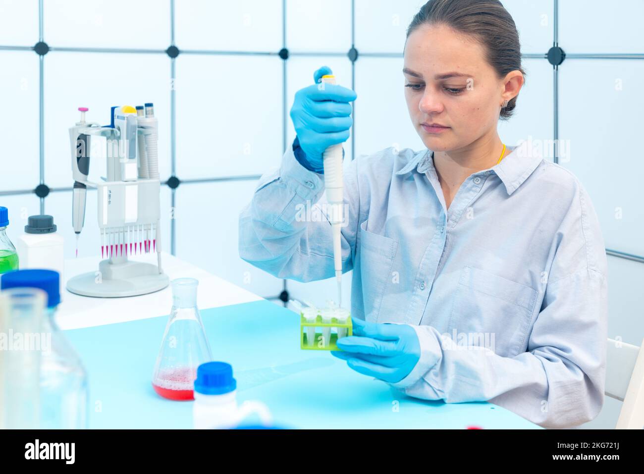 female laboratory assistant in microbiology laboratory use centrifuge ...