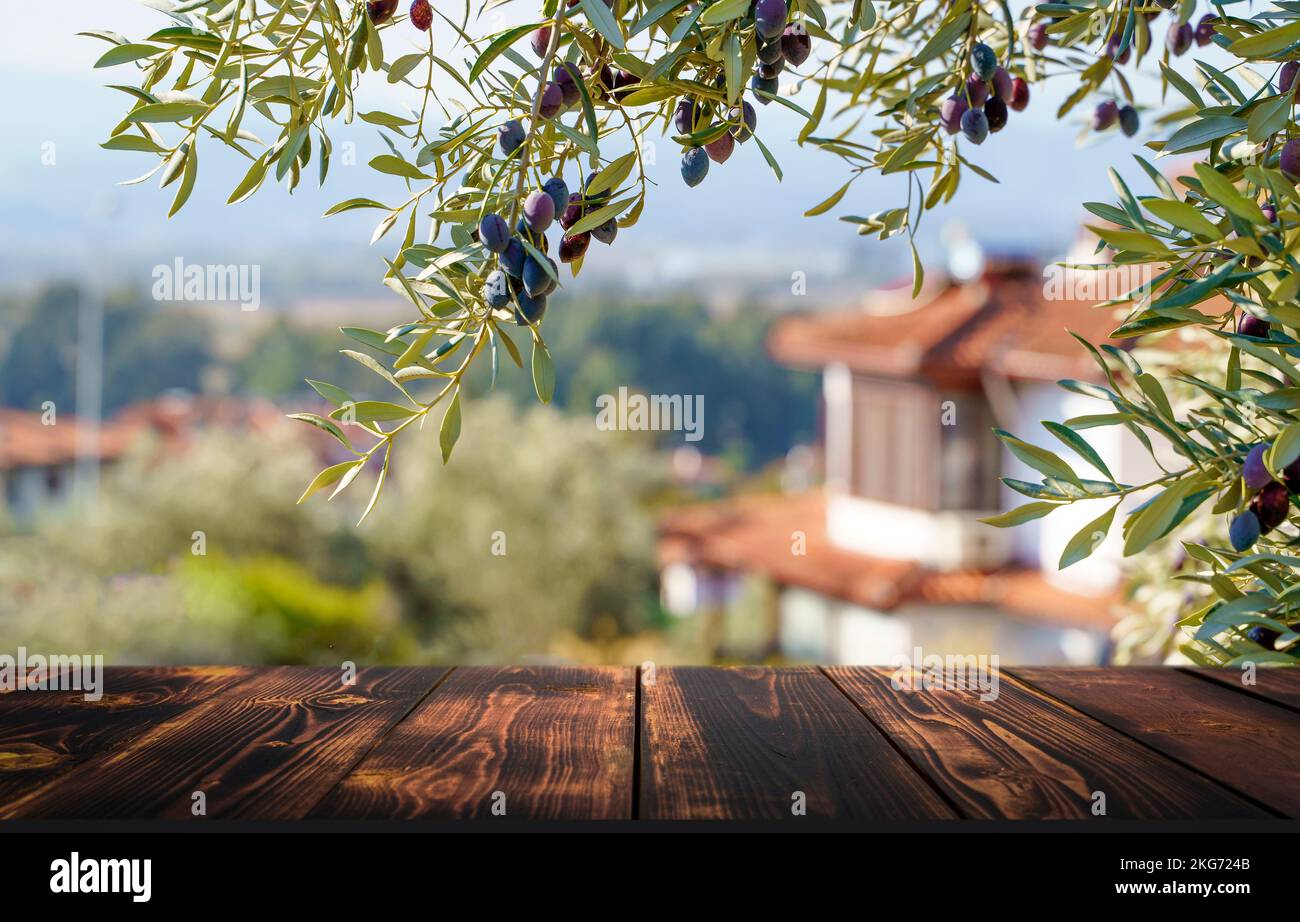 Wooden table on the background of olive trees and a farm garden. Summer ...