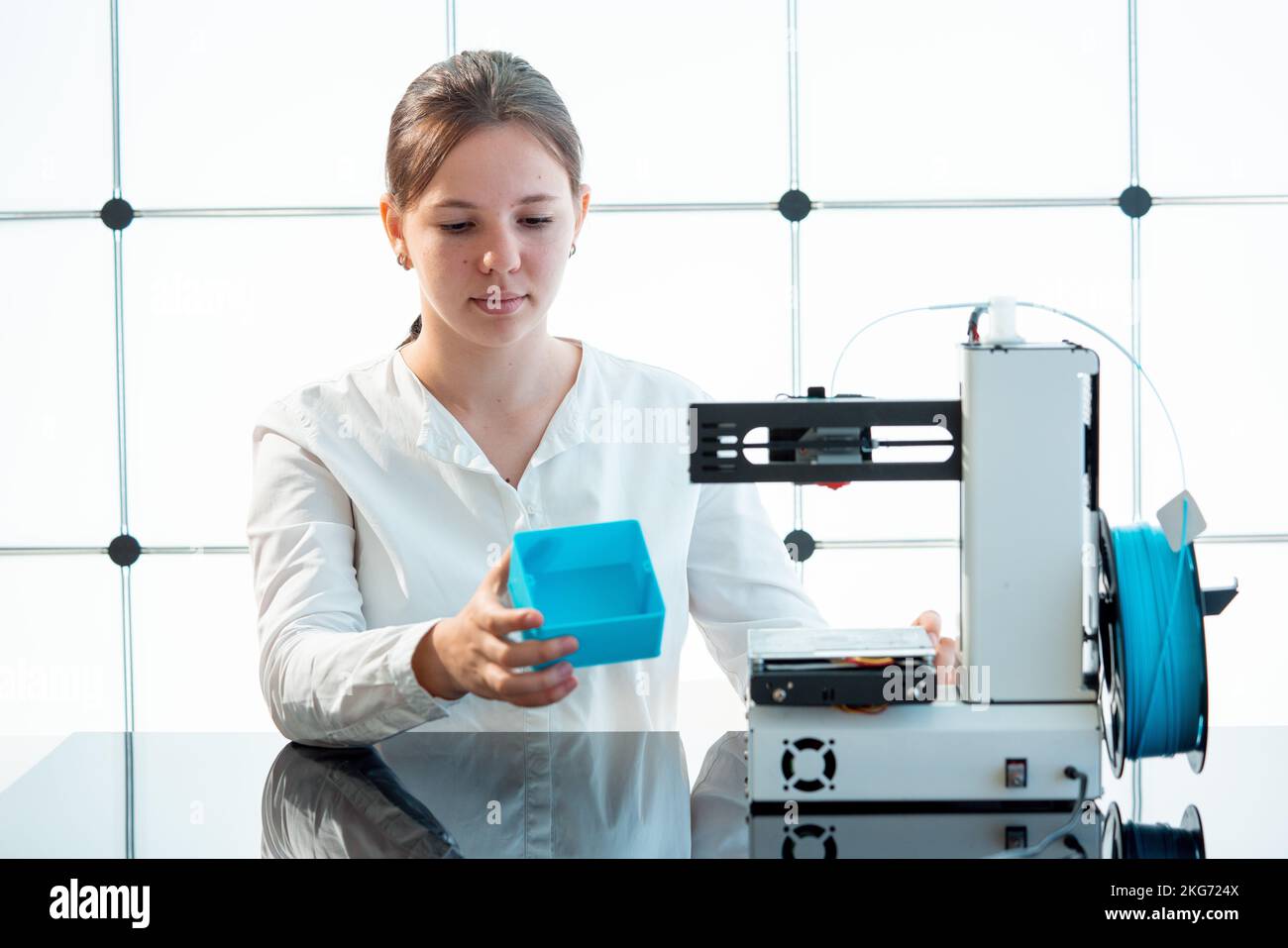 Young girl learning 3D printing at home, using a 3D printer , science ...