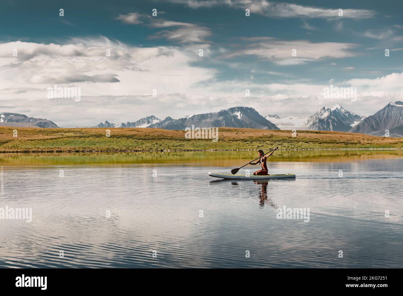 Beautiful sporty girl in bikini walks on sup standup paddle board at ...