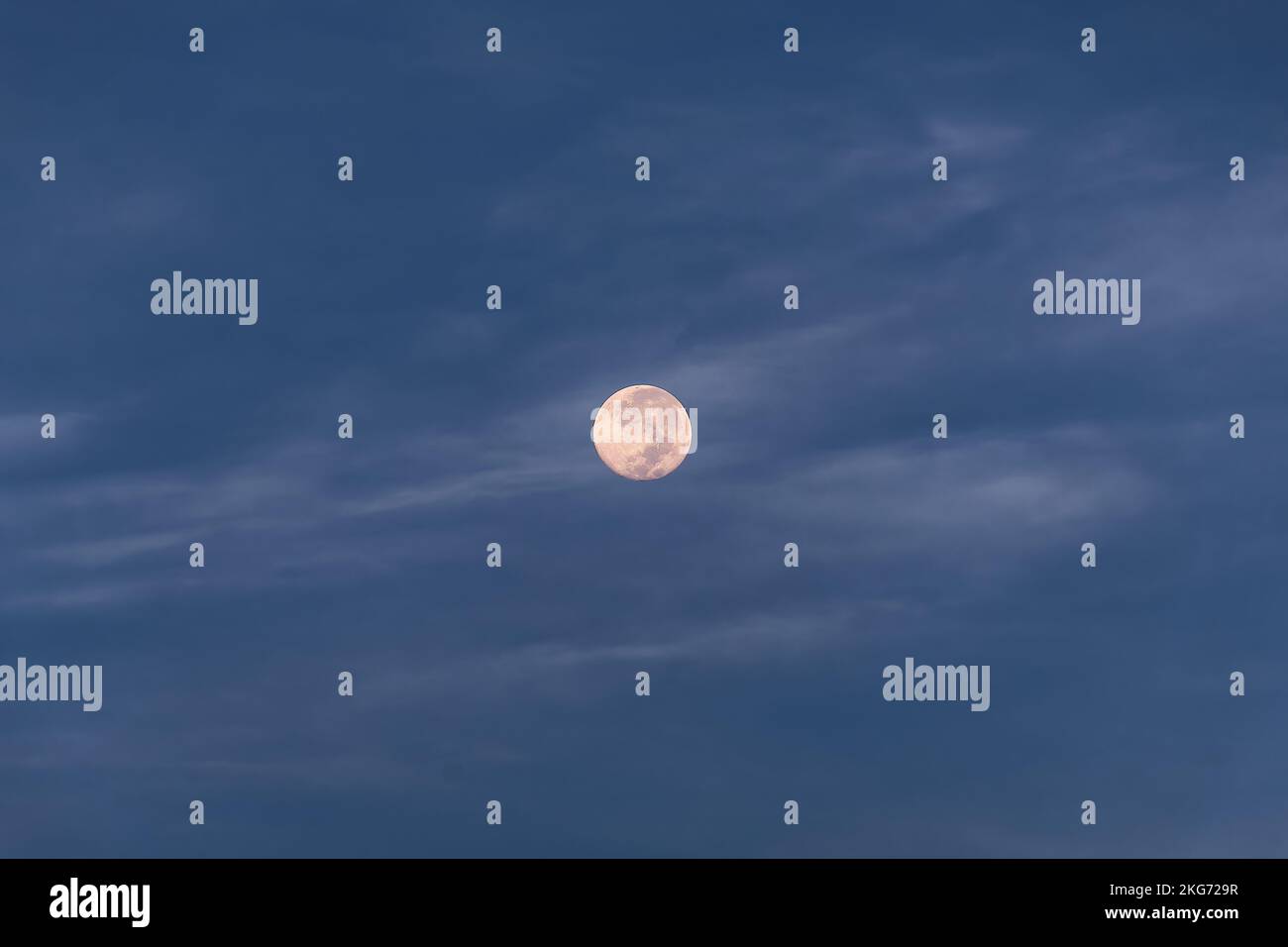 Full Moon Rising at Blue Hour with soft clouds Stock Photo - Alamy