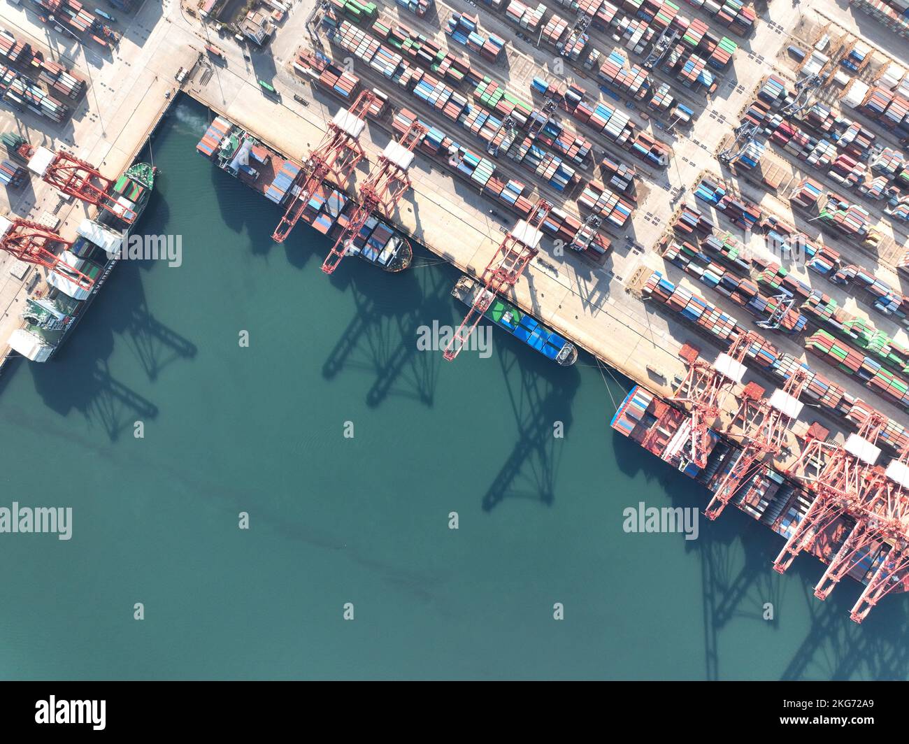 Aerial photos show cargo ships loading and unloading containers at the ...