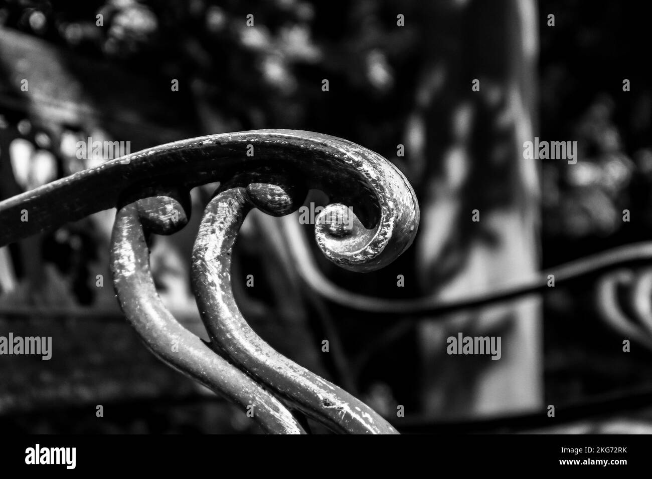 A black and white closeup shot of details of old bench handle in the ...