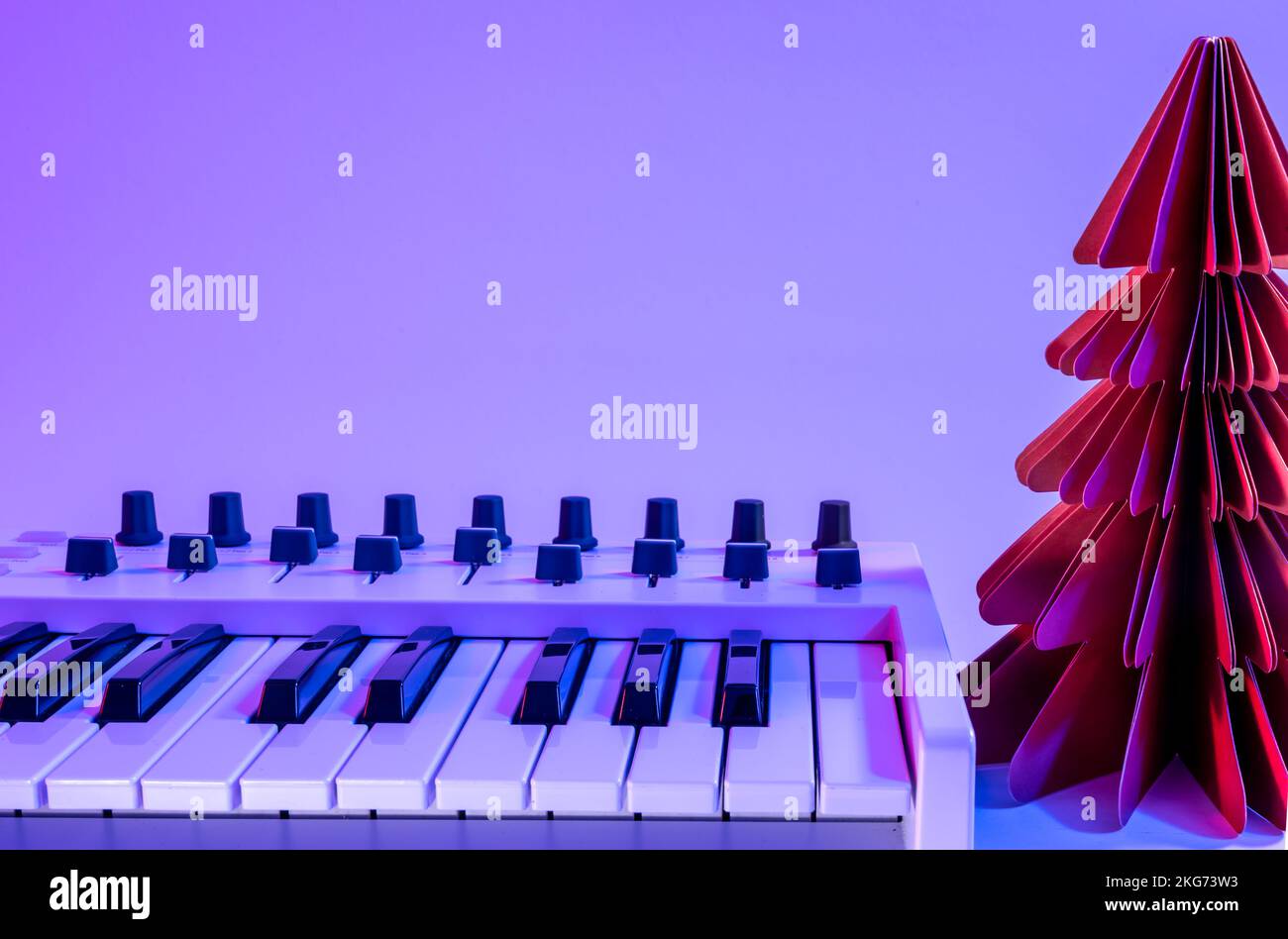 Christmas background with midi keyboard and holiday decor with neon ...