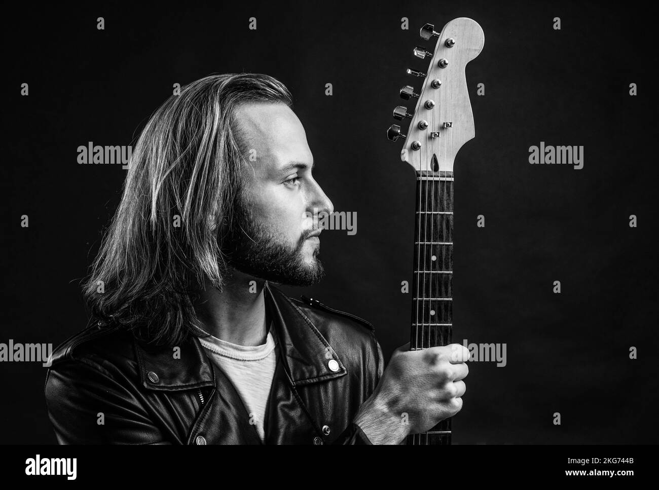 guitar neck. man long hair hold electric guitar fingerboard. rock music ...