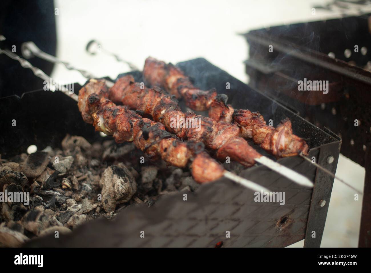 Meat is fried outside. Raw meat planted on blades. Heating food on ...