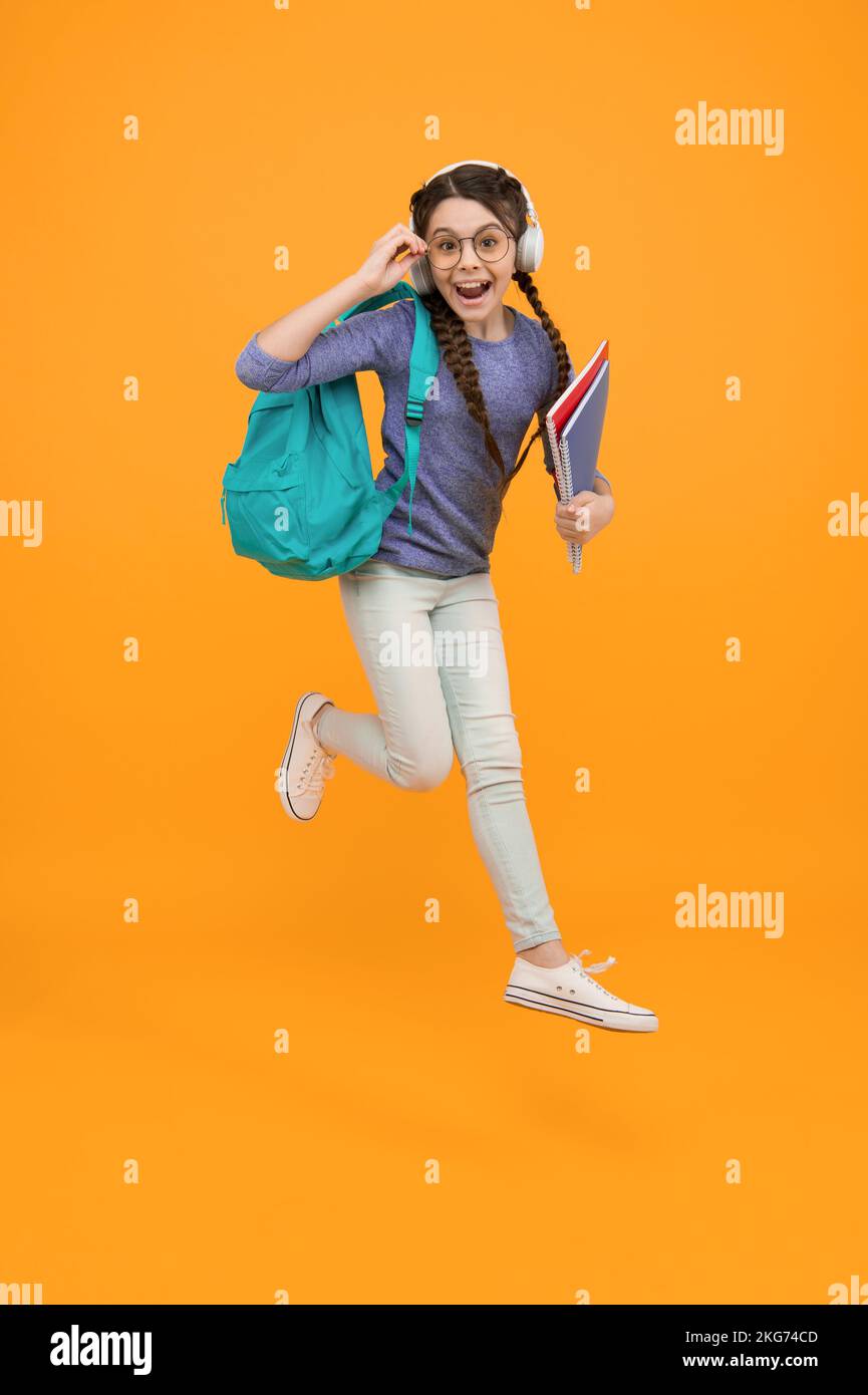 Unassailable childhood. Happy child in midair yellow background. Little ...