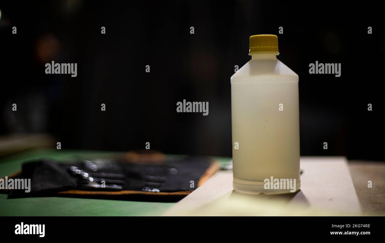 Glue on table. Container with glue. Object on table. White canister ...