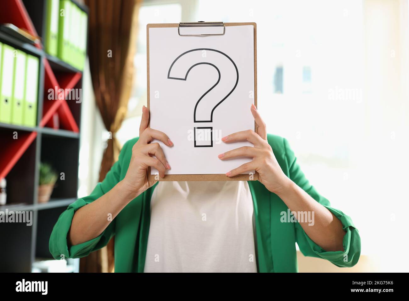 Confident business woman covering face with question mark sign Stock ...