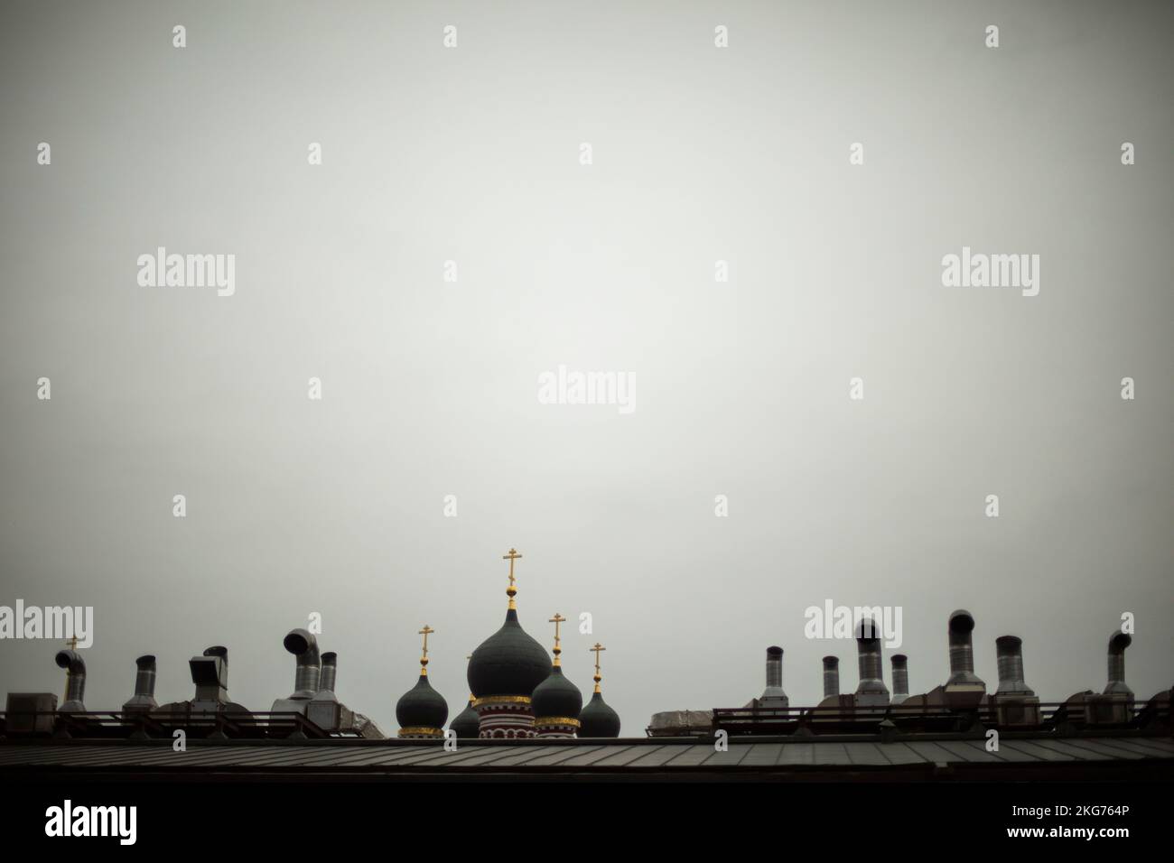 Roof of house and Orthodox cross. View of roof in city. Russian city in ...