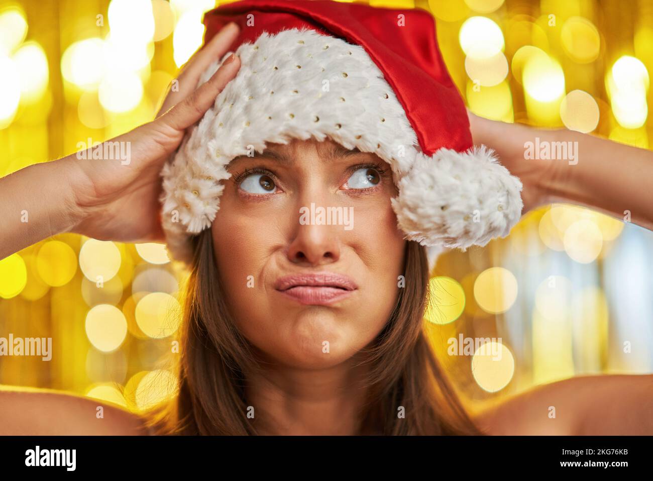 Woman over gold background making funny faces Stock Photo - Alamy