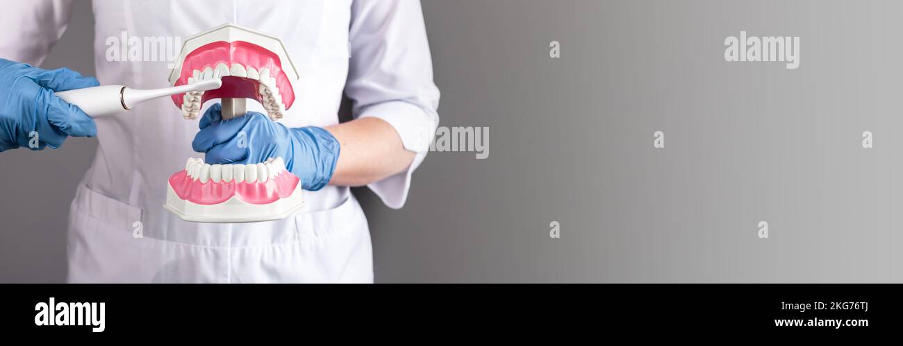 Brushing teeth jaw with electric toothbrush. Dental oral hygiene, ad ...