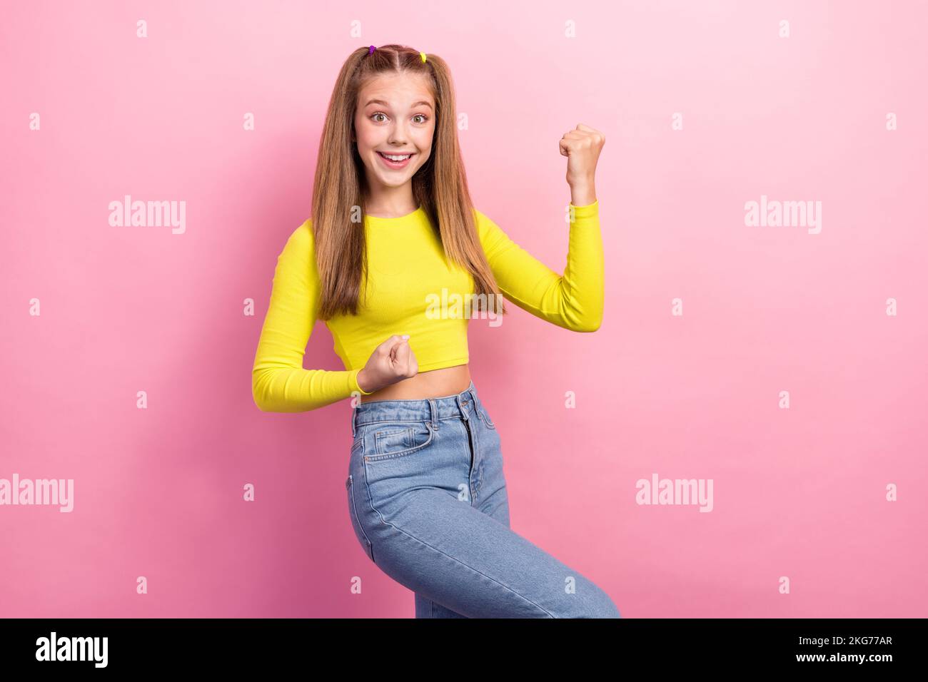 Portrait of positive impressed girl ponytails dressed yellow long ...