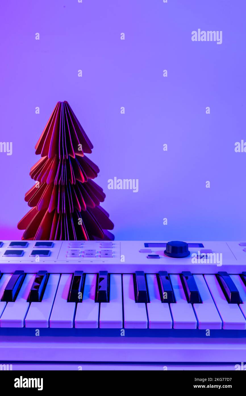 Christmas background with midi keyboard and holiday decor with neon ...