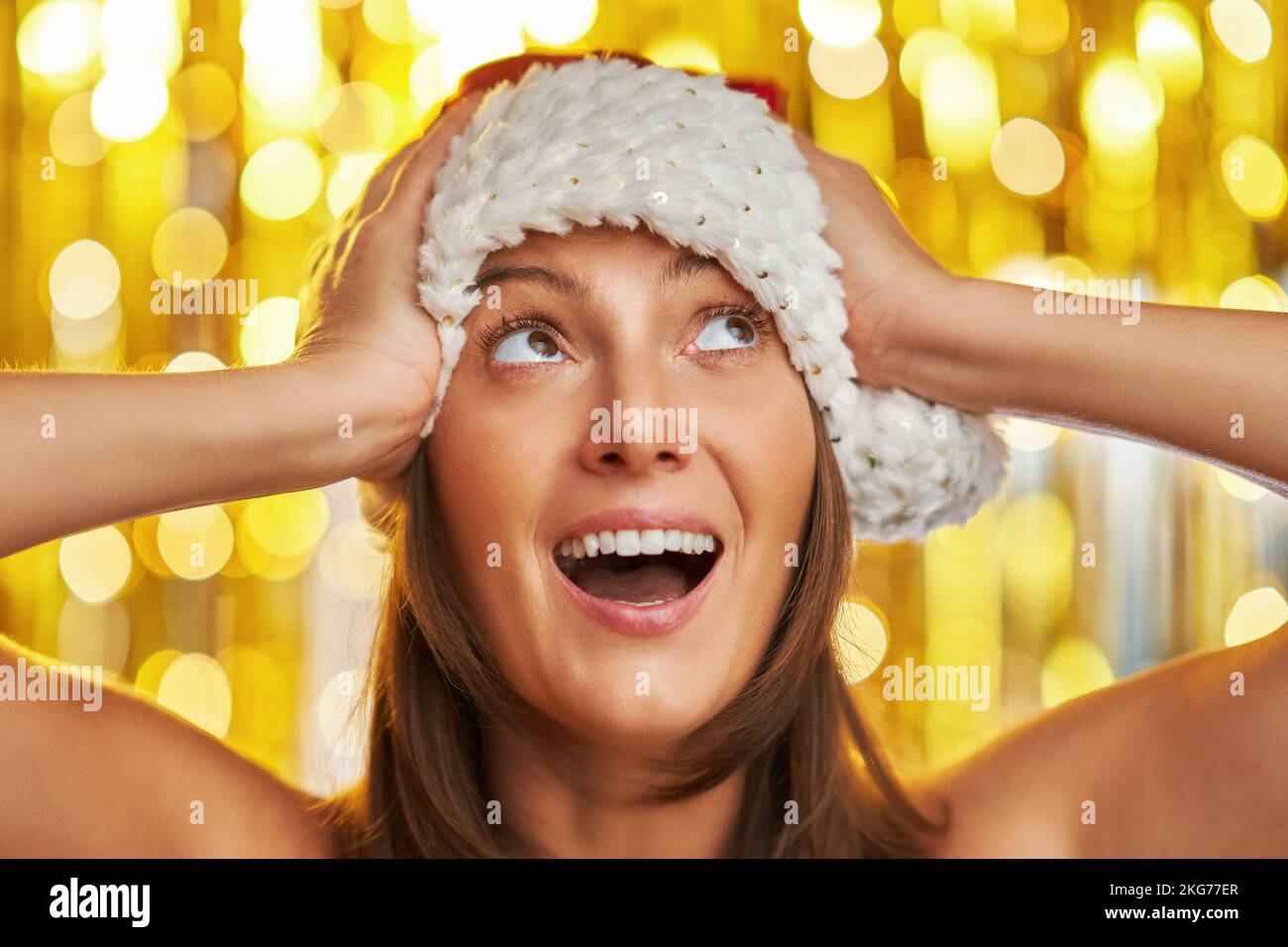 Woman over gold background making funny faces Stock Photo - Alamy