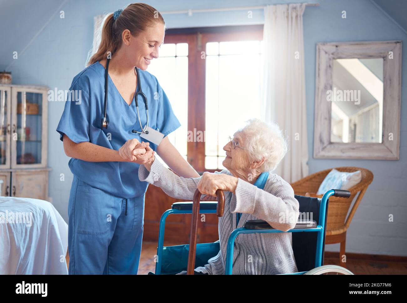 Senior woman, wheelchair and nurse for holding hands, disability support or nursing home ...