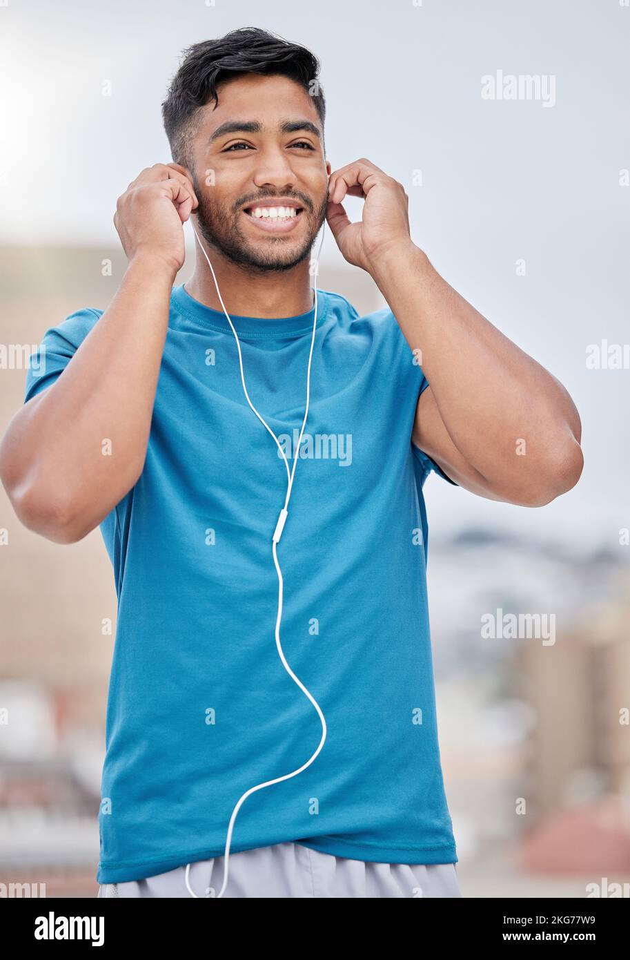 Man, music and earphones for city exercise for wellness, training and ...