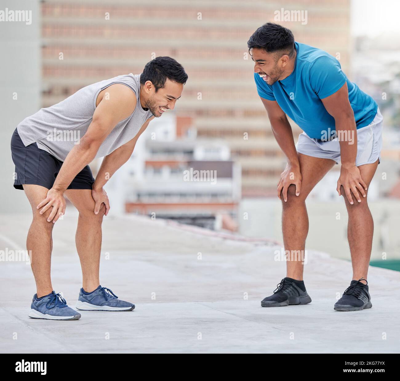 Fitness, exercise and friends talking on rooftop, comic joke and ...