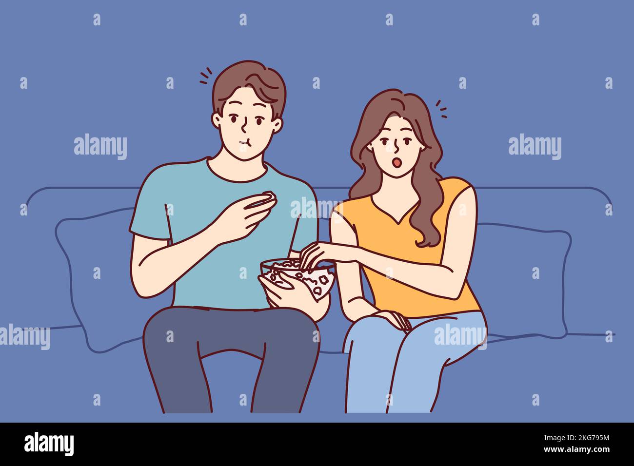 Couple watching movie eating popcorn at home. Young man and woman relax ...