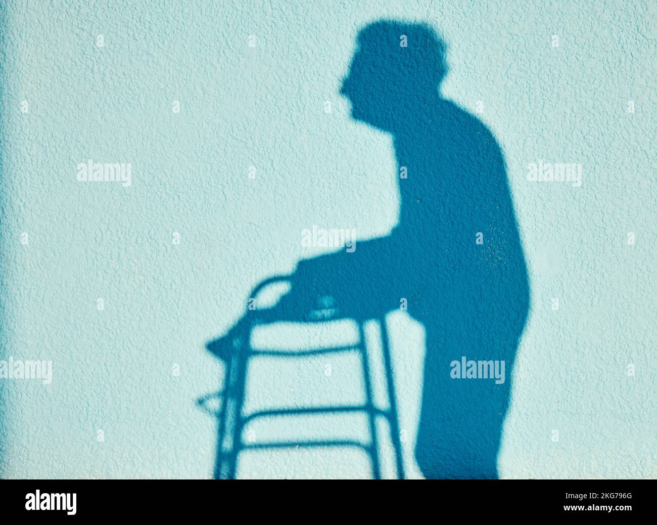 Shadow, disability and walking with a senior woman outdoor on a blue ...