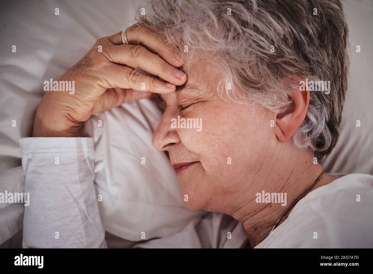 Sleep, headache and senior woman in a bed with stress, anxiety and ...
