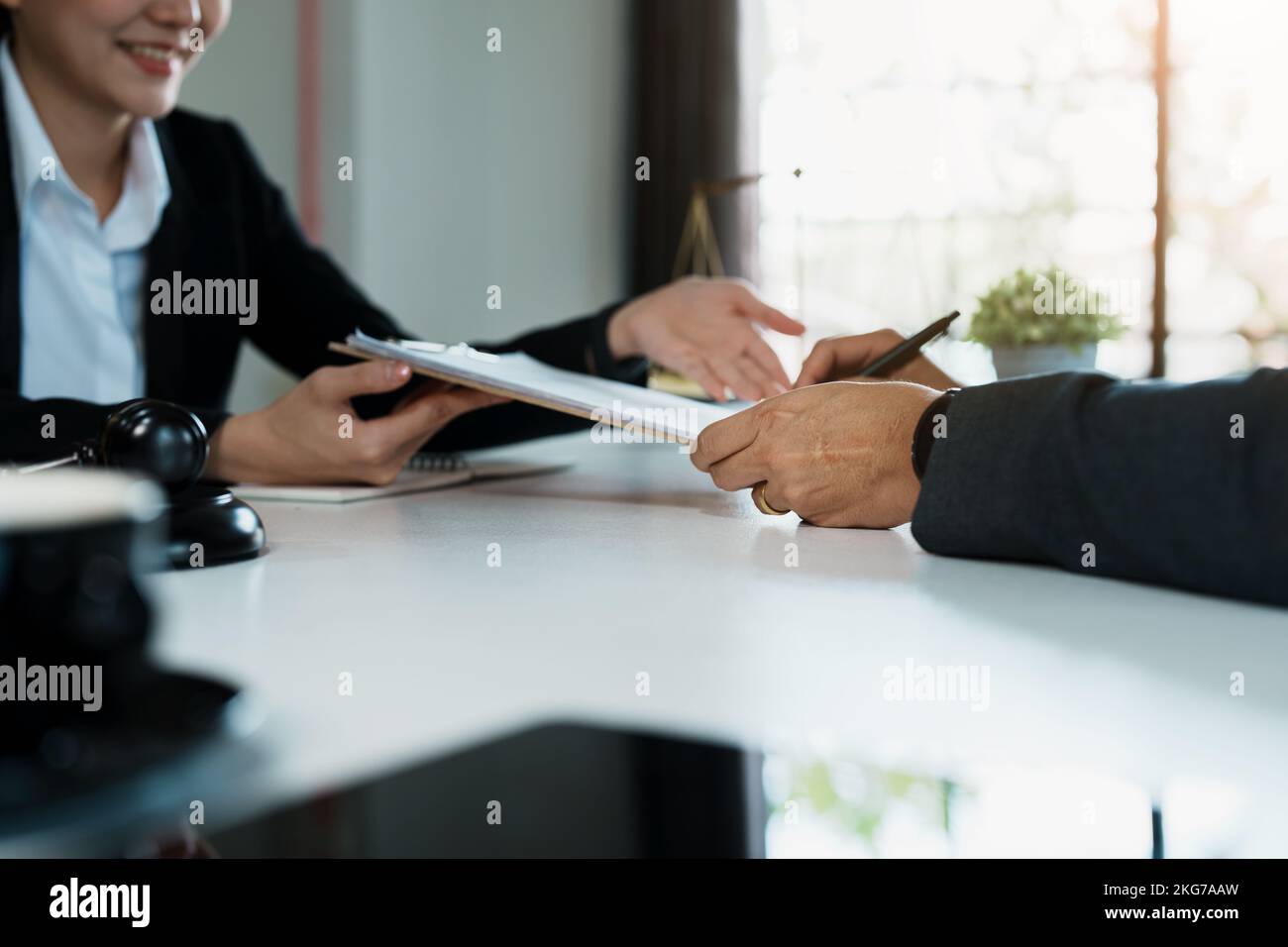 The signing of important documents between the lawyer and the client to ...