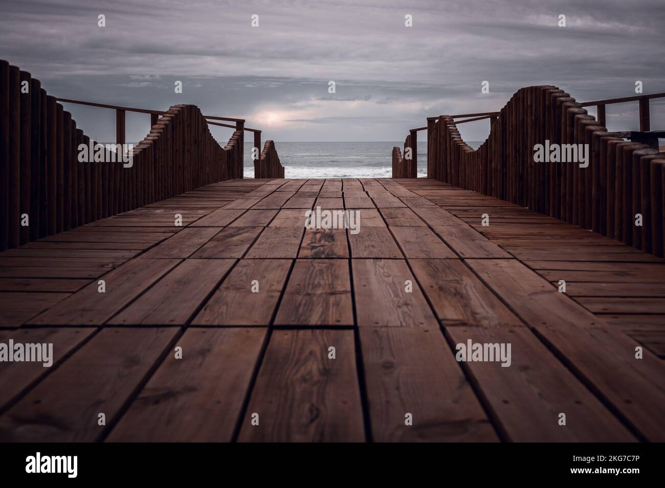 Long wooden pier boardwalk in Quiaios beach with low viewpoint ...