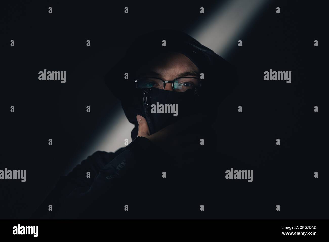 line Dim lighting with shadows on a man with high-collar outdoor jacket ...