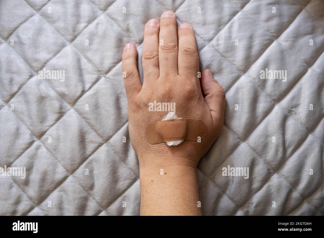 A top view shot of a hand with Sticker Plaster bandage post op on ...
