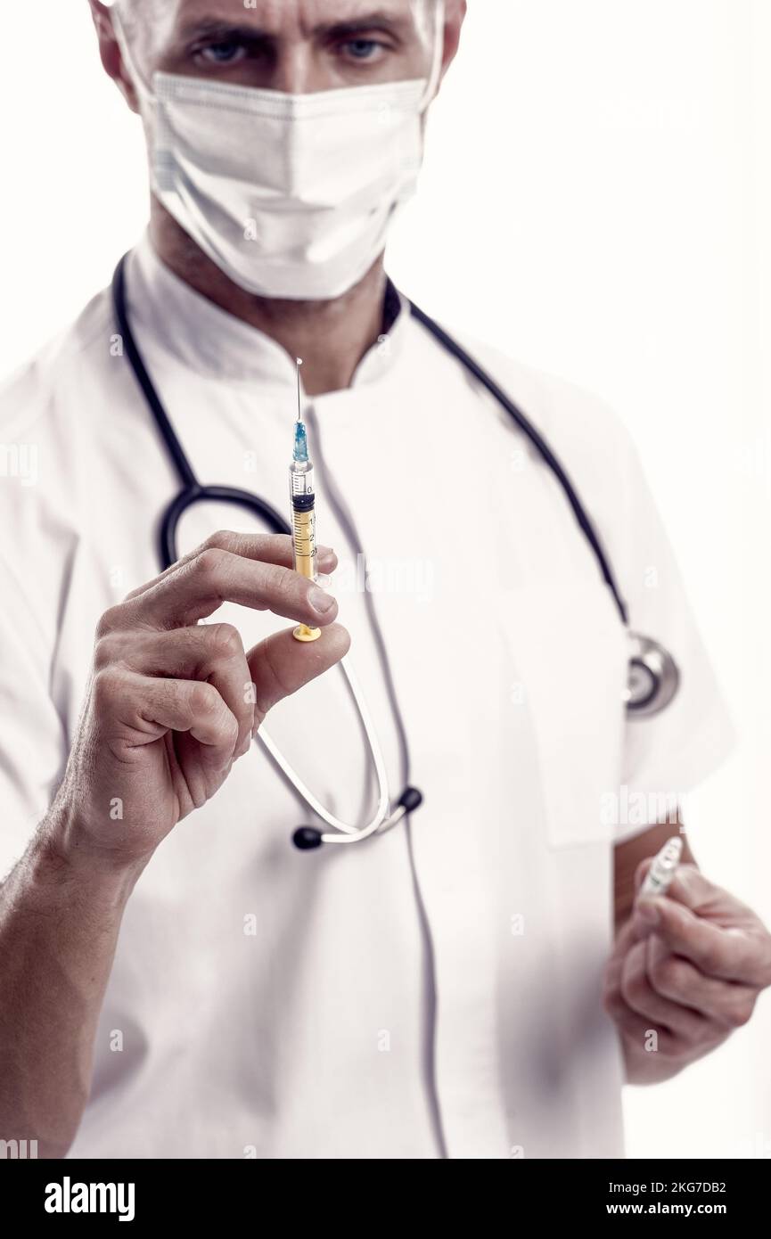 Covid-19 vaccine syringe with needle in hands of physician wearing ...
