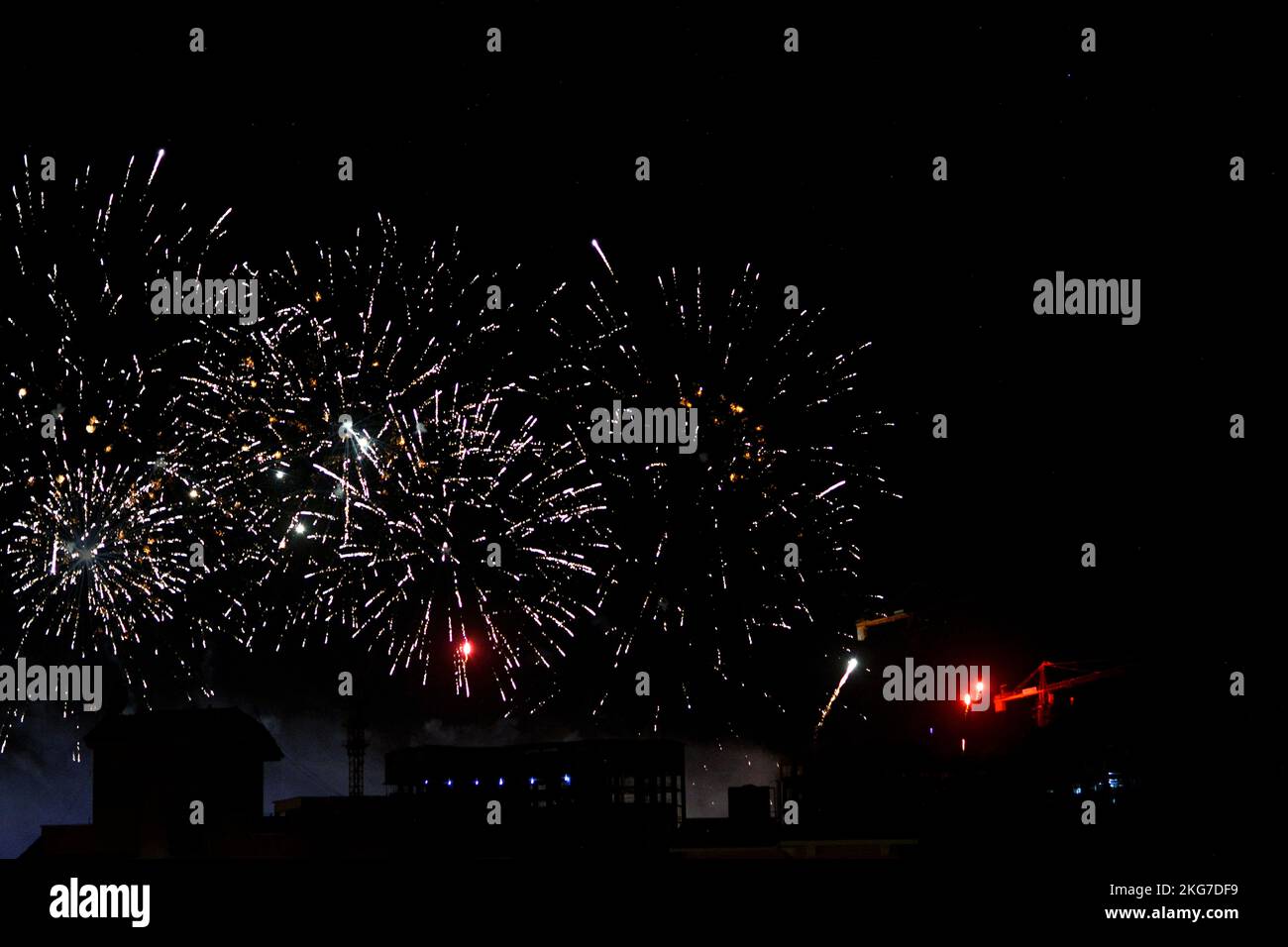colorful fireworks at night with shadows of a construction site and ...