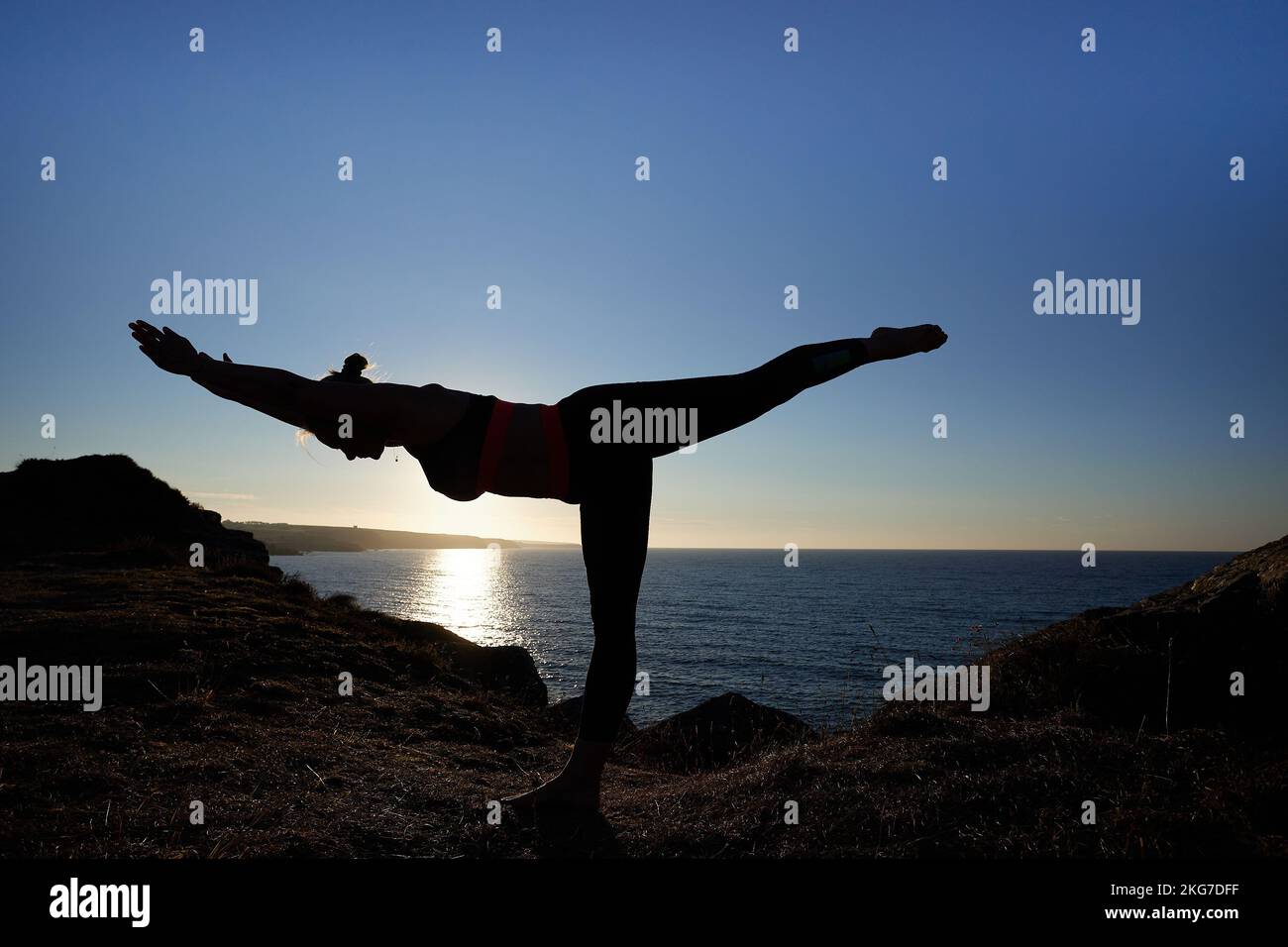 silhouette of woman performing Natarajasana yoga pose, backlit with no ...