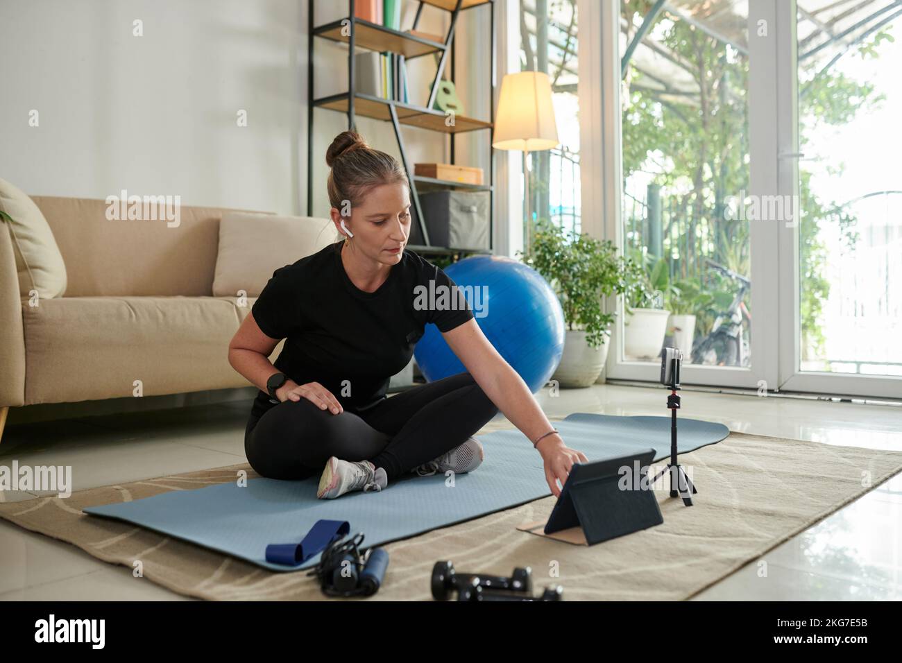 Online fitness instructor getting ready to film video at home for ...