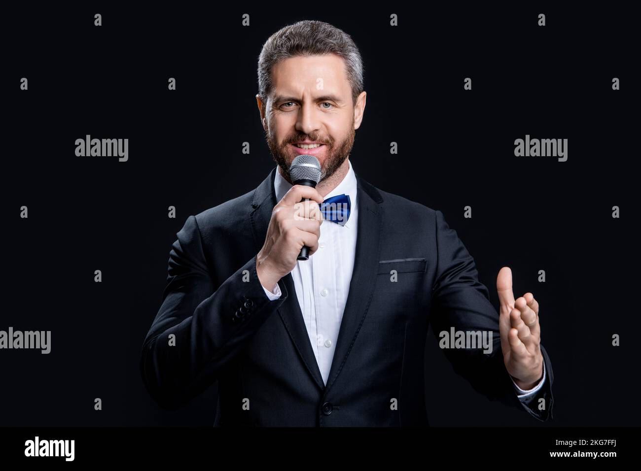 happy tuxedo man presenter isolated on black background. man presenter ...