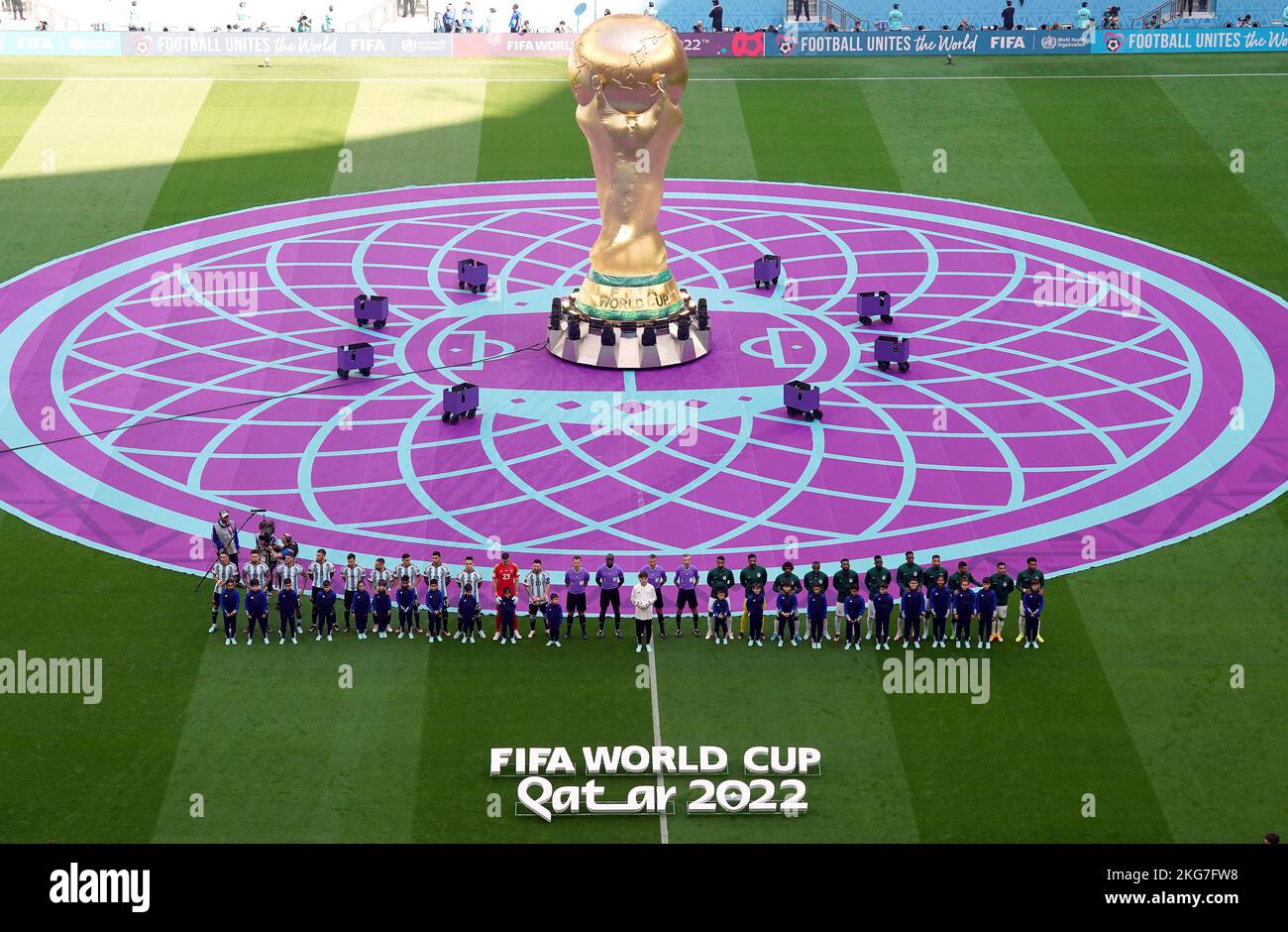 Argentina and Saudi Arabia players line up in front of a giant replica ...